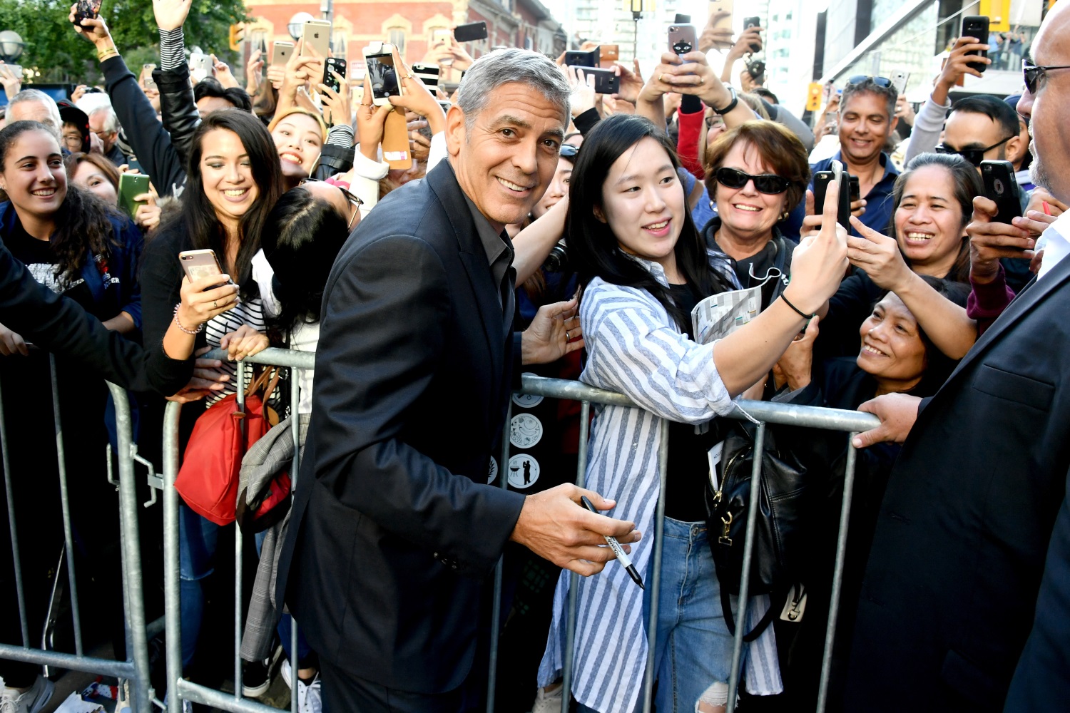 George Clooney poses for photo with fan | Toronto International Film ...