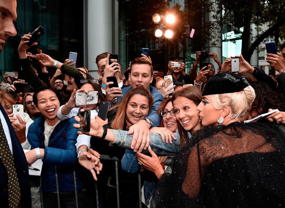 Lady Gaga poses with fans on the red carpet | Toronto International ...